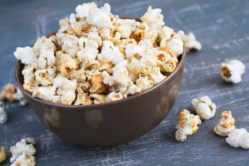 Sweet Caramel Popcorn in a Bowl on a Dark Blue Background Stock Photo ...
