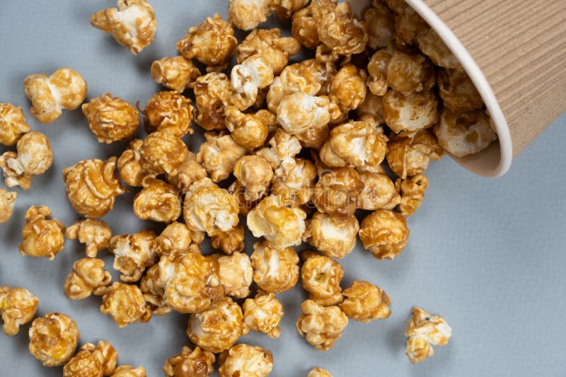 Sweet Caramelized Popcorn Spilled Out of the Glass. Stock Photo - Image ...