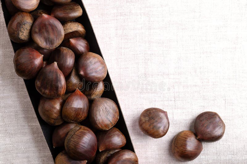 Sweet Chestnuts in Cardboard Punnet on Linen, from Above Stock Photo ...