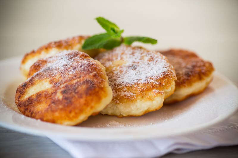 Sweet Cooked Cheesecakes in Powdered Sugar in a Plate Stock Image ...