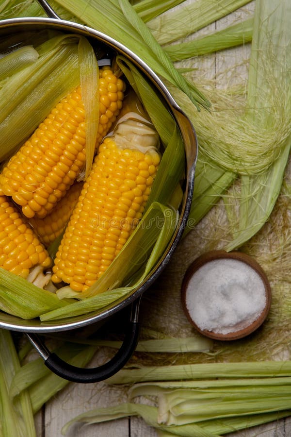 Sweet Corn Boil with Salt. Cooked Sweet Corn in Pot on Wooden Table ...