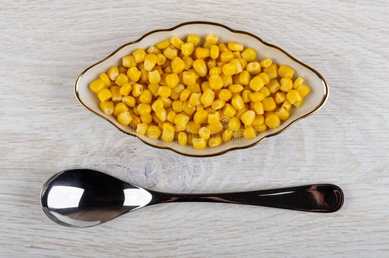 Sweet Corn in Plate, Spoon on Wooden Table. Top View Stock Photo ...