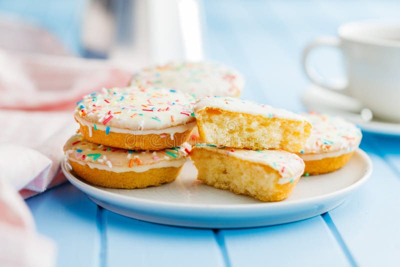 Sweet Dessert with Sugar Coating on Plate on Blue Table Stock Photo ...