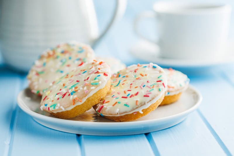 Sweet Dessert with Sugar Coating on Plate on Blue Table Stock Image ...