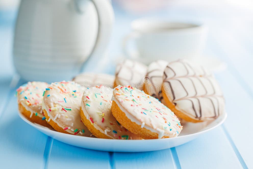 Sweet Dessert with Sugar Coating on Plate on Blue Table Stock Photo ...
