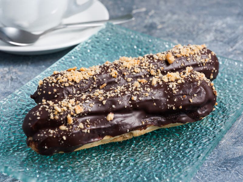 Sweet Eclair with Chocolate on a Glass Plate Stock Image - Image of ...