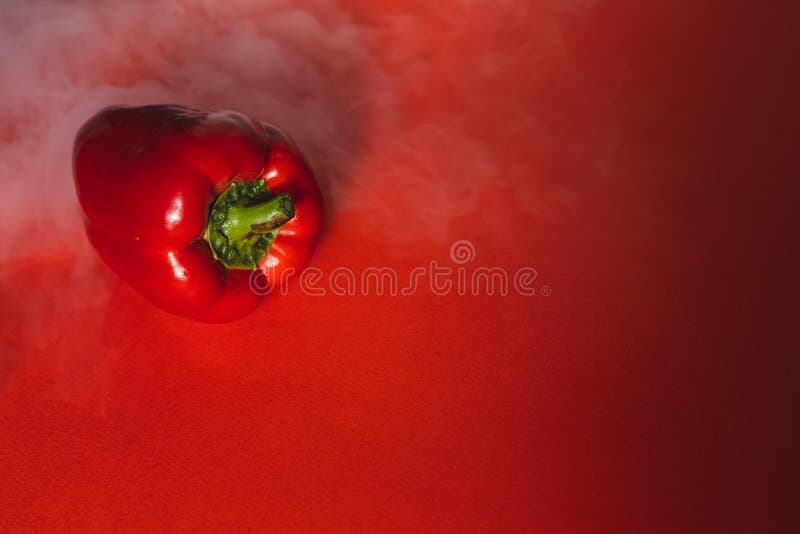 SWEET, Fresh RED PEPPER on a RED BACKGROUND with a LIGHT SMOKE Stock ...