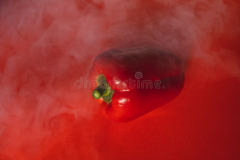 SWEET, Fresh RED PEPPER on a RED BACKGROUND with a LIGHT SMOKE Stock ...