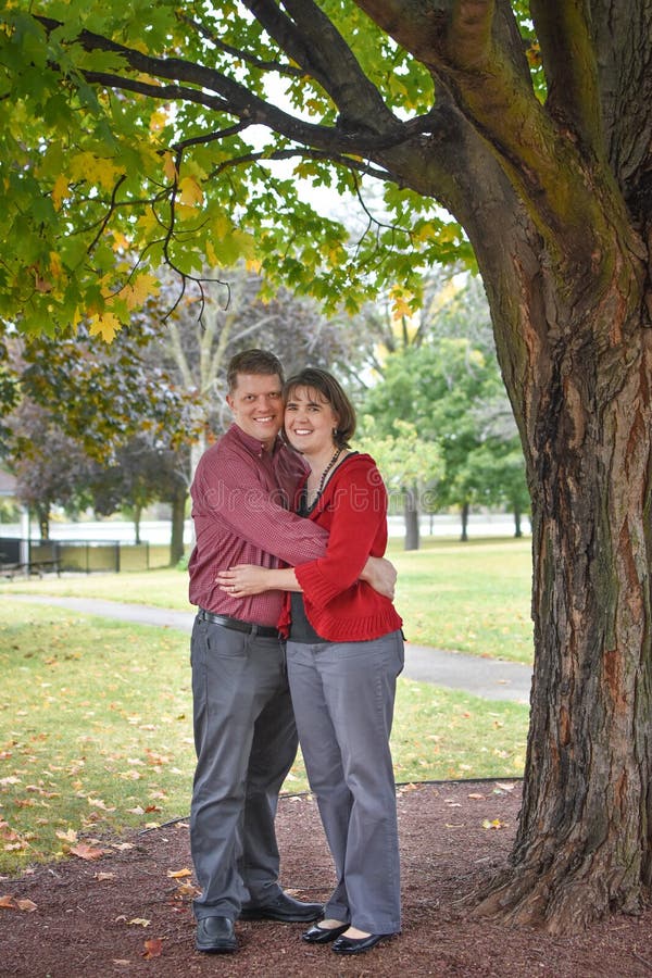 Married Couple Under Tree Hugging Each Other Stock Image - Image of ...