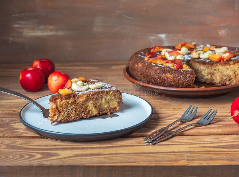 A Portion of Homemade Cake with Fruit and Sour Cream on a White Saucer ...