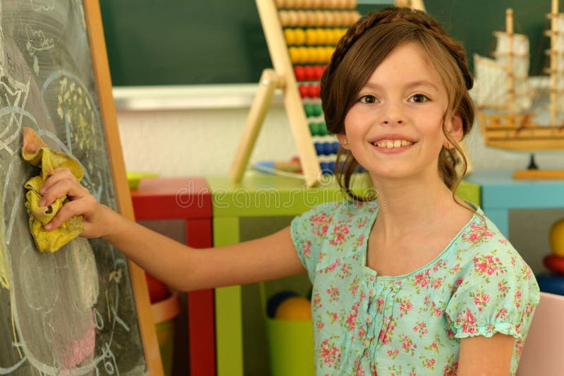 Sweet Little Girl Learning Happily in Front of Her Blackboard Stock ...