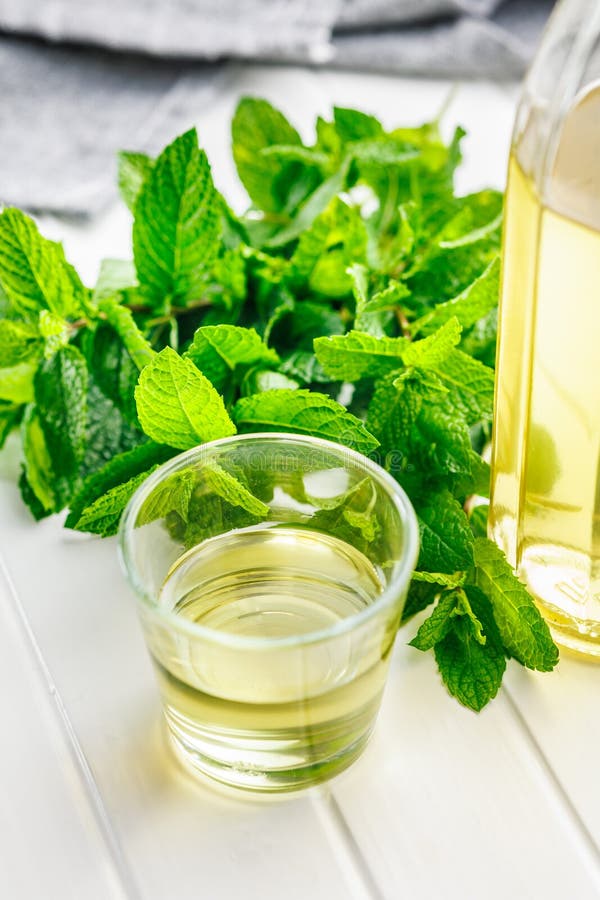 Sweet Mint Syrup and Mint Leaves on White Table Stock Image - Image of ...