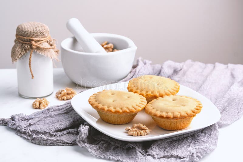 Sweet Pastries, a Bottle of Milk and a Mortar with Nuts Stock Photo ...