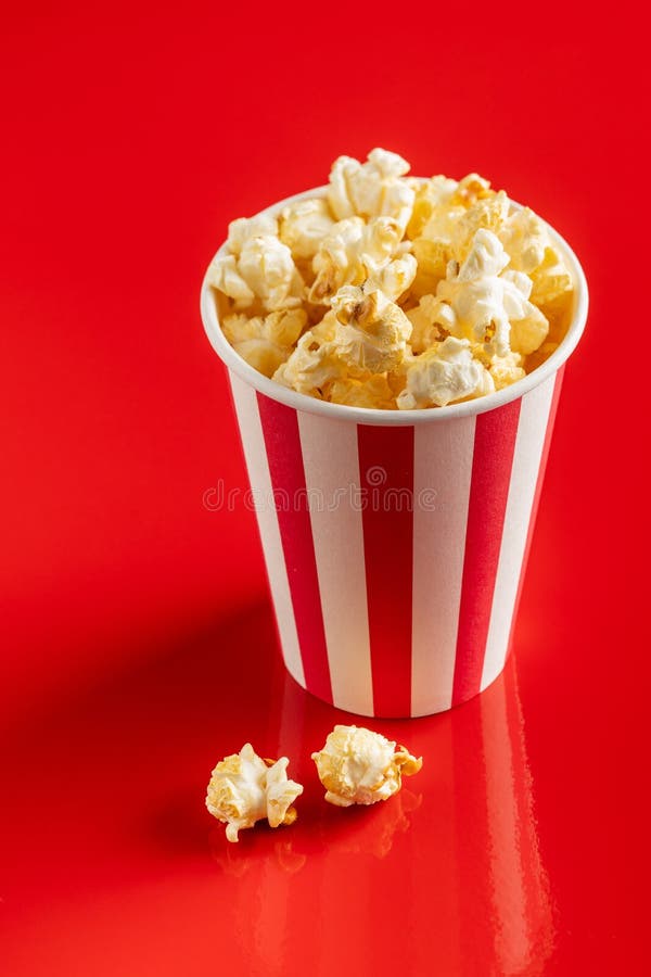Popcorn in paper cup stock photo. Image of cinema, salty - 77764666