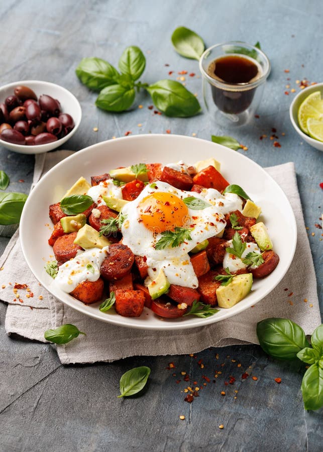 Sweet Potato and Chorizo Hash with Egg, Avocado and Herbs. Stock Photo ...