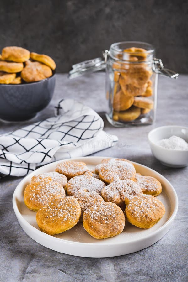 Sweet Pumpkin Cookies in Powdered Sugar on a Plate on the Table ...