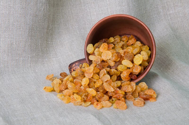 SweetÂ raisinsÂ areÂ scatteredÂ fromÂ theÂ cup Stock Image - Image of ...