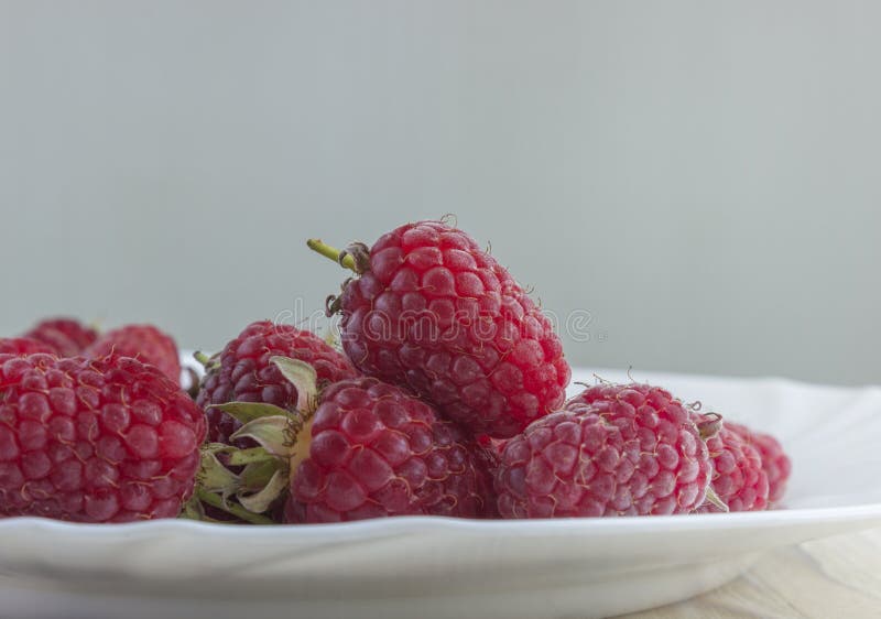 Sweet Raspberries on Plate on Wooden Table Stock Image - Image of ...