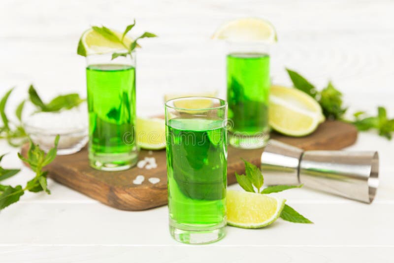 Sweet Refreshing Mint Liqueur, with Ice and Mint Leaves on Table ...