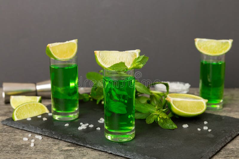Sweet Refreshing Mint Liqueur, with Ice and Mint Leaves on Table ...