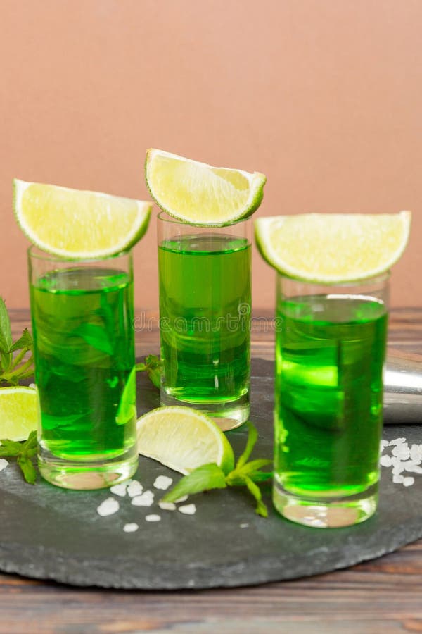 Sweet Refreshing Mint Liqueur, with Ice and Mint Leaves on Table ...