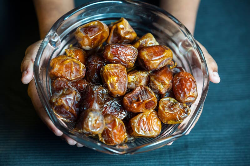 Sweet Traditions -Child S Hand Offering Dates for Ramadan Stock ...