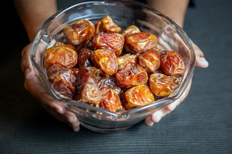 Sweet Traditions -Child S Hand Offering Dates for Ramadan Stock Image ...