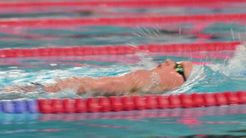 Swimmer Boy Swims Backstroke Swimming Style in the Pool. Stock Footage ...