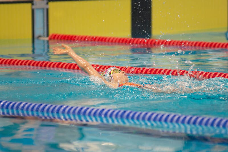 Swimmer Child Swims Backstroke Swimming Style in the Pool Stock Photo ...