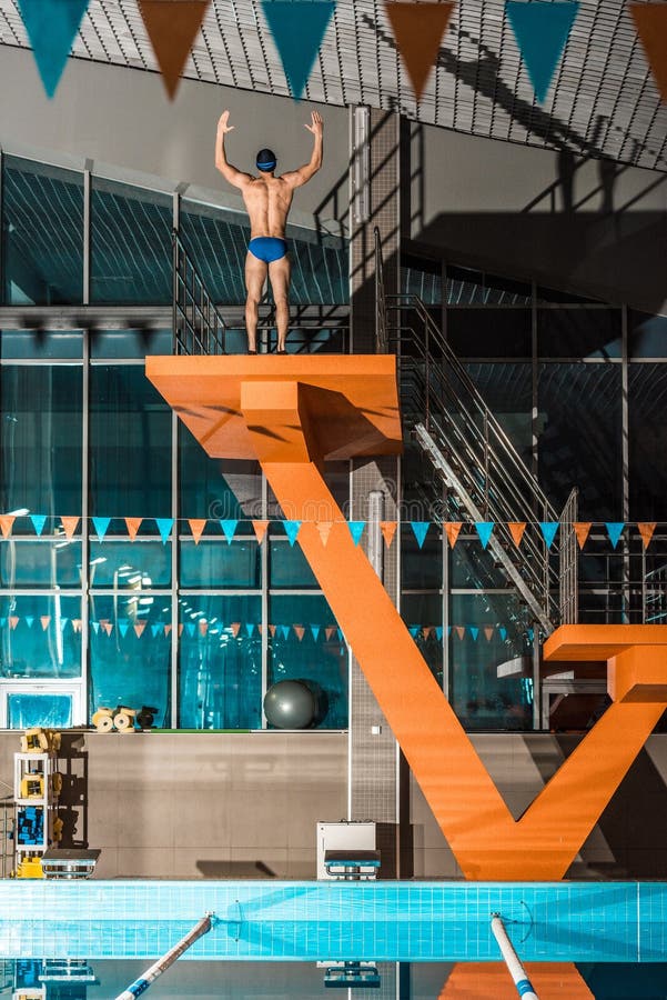Man Standing On Diving Board At Public Swimming Pool Stock Image ...