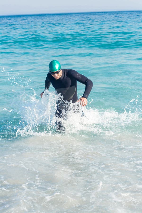 Swimmer Running Out of Ocean Finishing Swim Race Stock Image - Image of ...