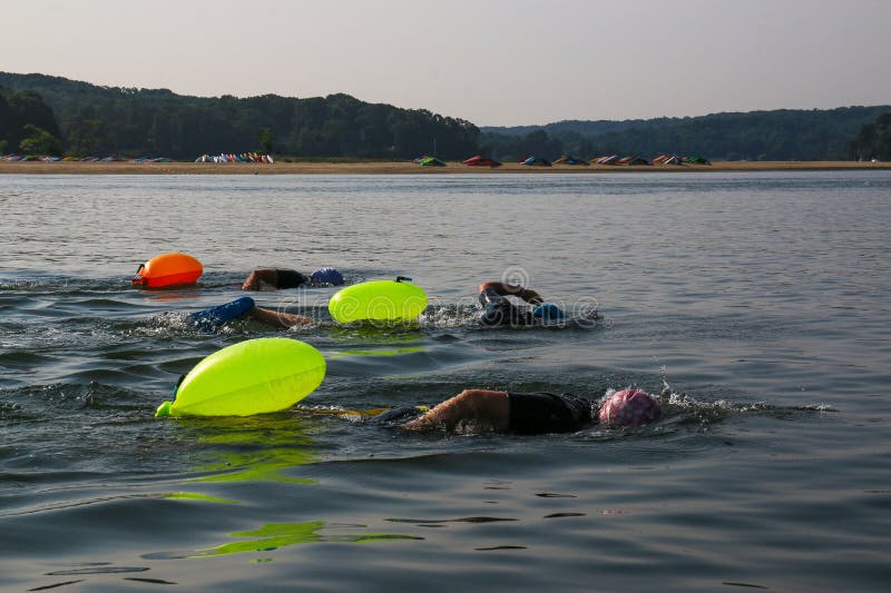Swimmers with Floatation Devices Swimming Together Stock Photo - Image ...