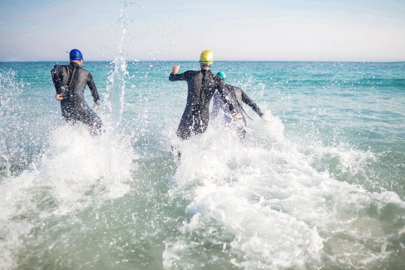 Swimmers Running in the Ocean Stock Photo - Image of swimming, vacation ...