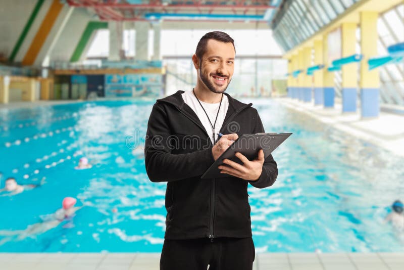 Swimming Coach Writing a Document Next To a Pool Stock Image - Image of ...
