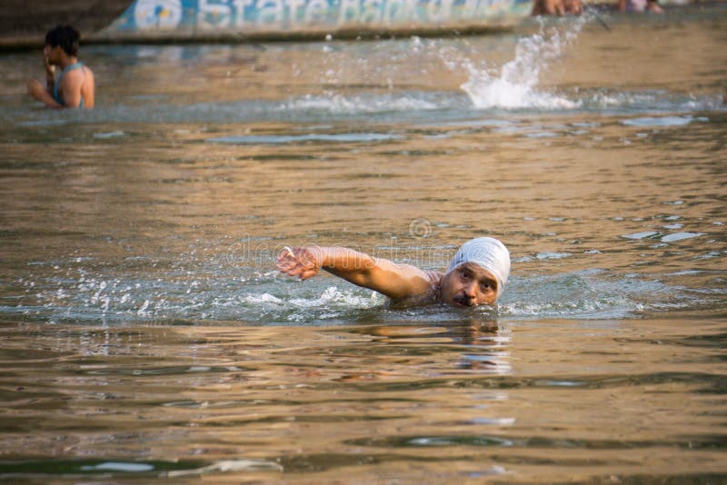 Boy Is Swimming In The Ganga River In India. Editorial Photo - Image of ...