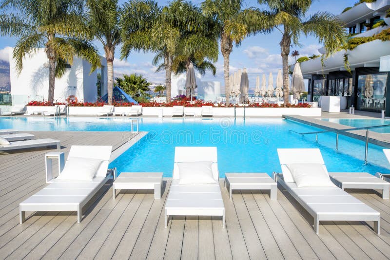 Swimming Pool Area with White Sun Beds at the Modern Resort. Stock ...