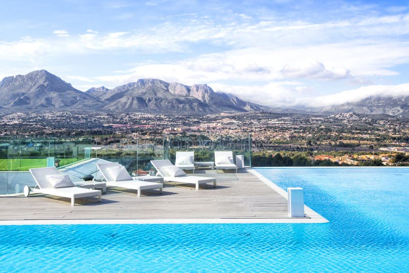 Swimming Pool Area with White Sun Beds at the Modern Resort. Stock ...