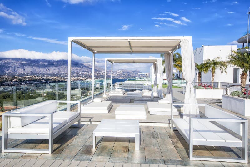 Swimming Pool Area with White Sun Beds at the Modern Resort. Stock ...