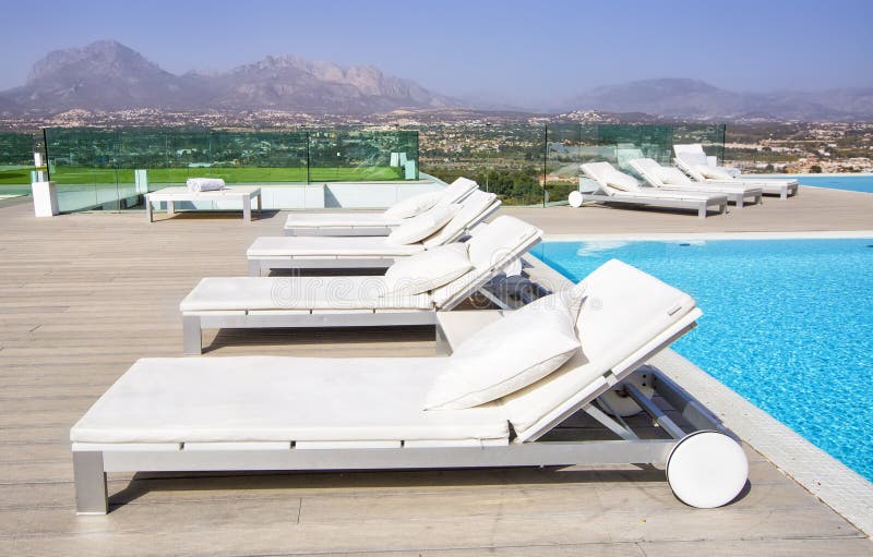 Swimming Pool Area with White Sun Beds at the Modern Resort. Stock ...