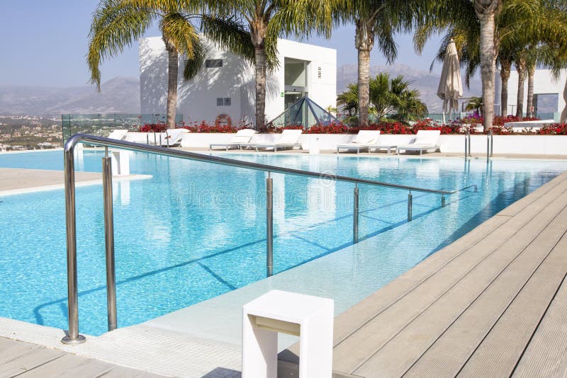 Swimming Pool Area with White Sun Beds at the Modern Resort. Stock ...