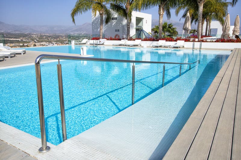 Swimming Pool Area with White Sun Beds at the Modern Resort. Stock ...