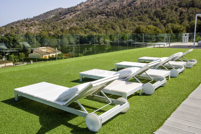 Swimming Pool Area with White Sun Beds at the Modern Resort. Stock ...