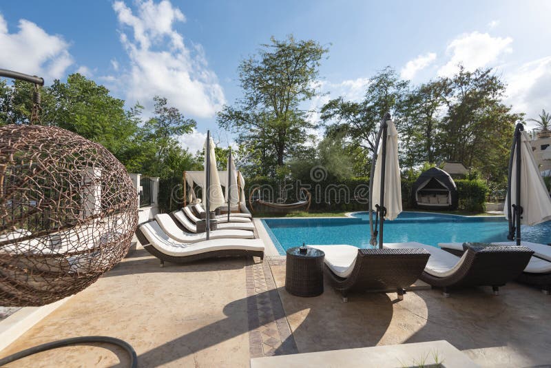 Swimming Pool Area with White Sun Beds. Summer Vacation Stock Image ...