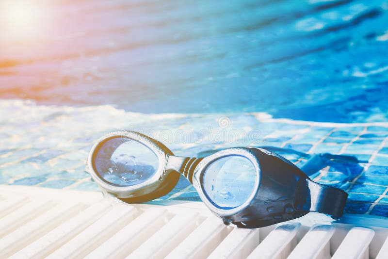 Swimming Pool Goggles on the Poolside Stock Photo - Image of accessory ...