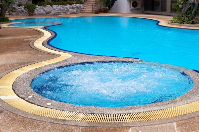 Swimming pool with jacuzzi stock image. Image of holiday - 180673003