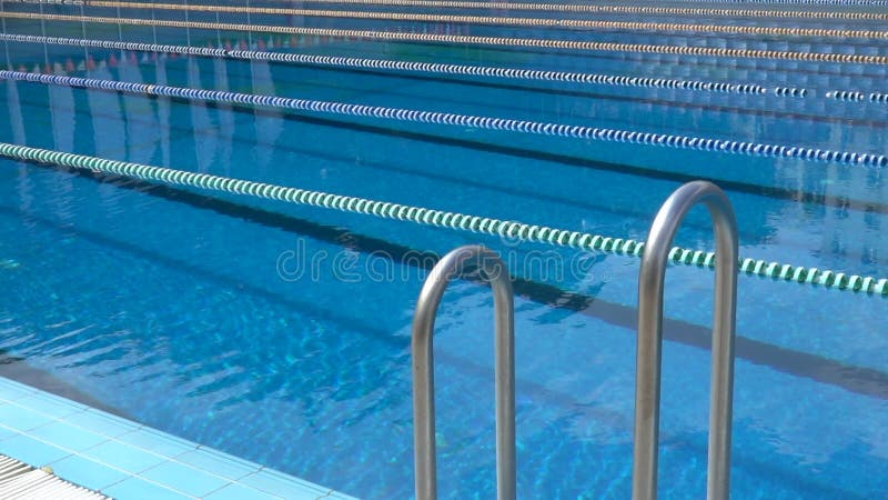Swimming Pool with Pool Ladder. Handrails To Stairs Leading To Pool ...