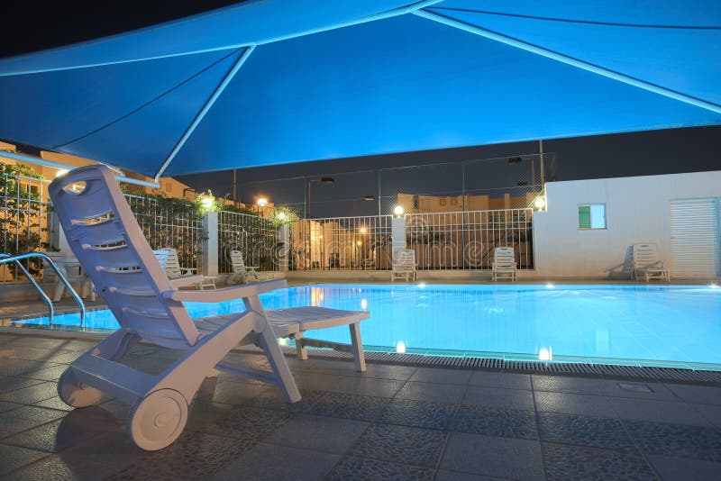 Patio and Pool by Night-2 stock image. Image of chair - 1732503