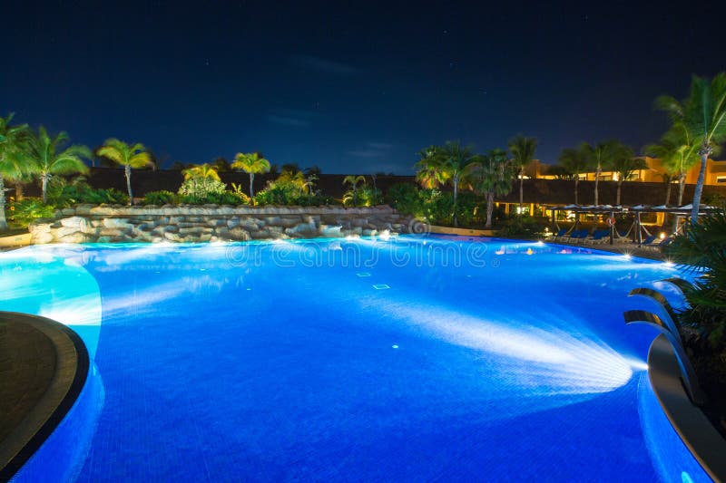 Swimming pool in night stock photo. Image of tropical - 264743996