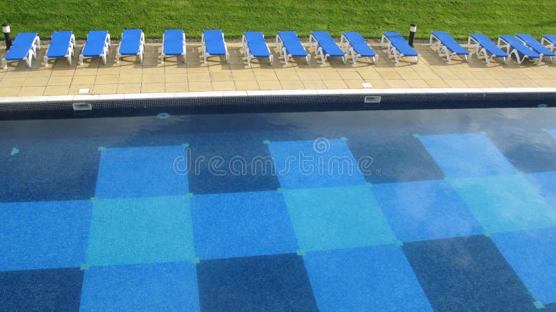 Swimming Pool and Row of Deck Chairs Stock Image - Image of chairs ...