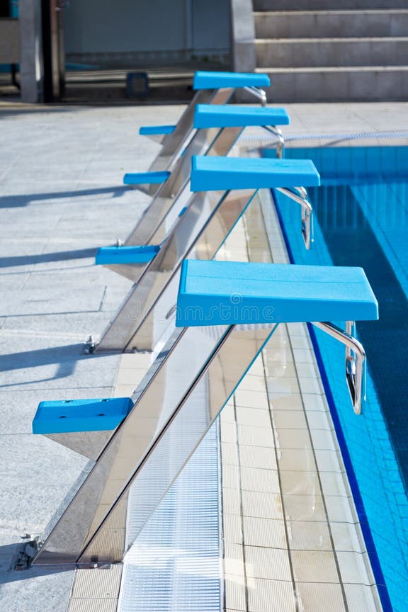 Swimming Pool Starting Blocks in a Row Stock Photo - Image of start ...